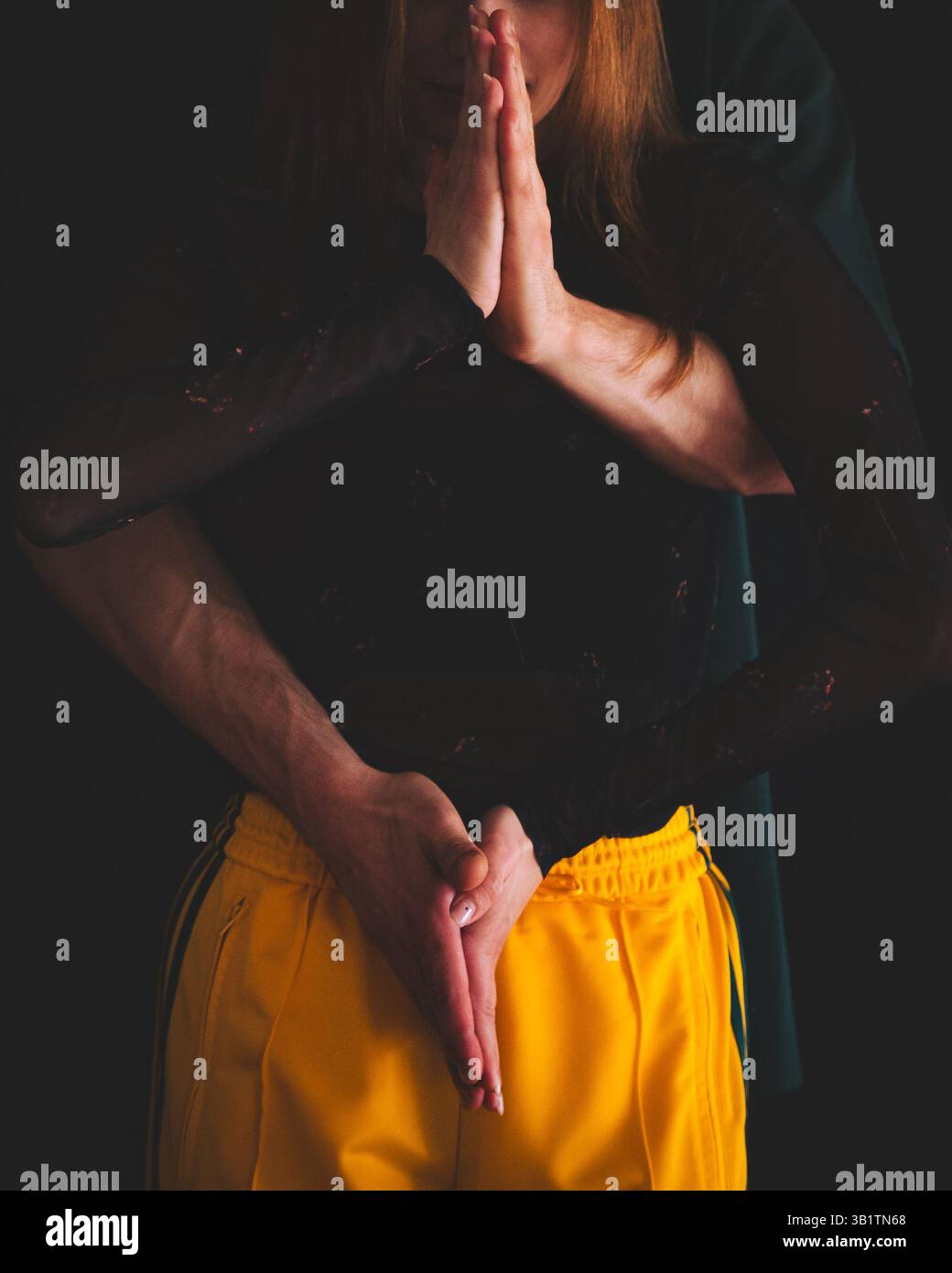 Couple embracing and holding hands in prayer, seeking spiritual ...