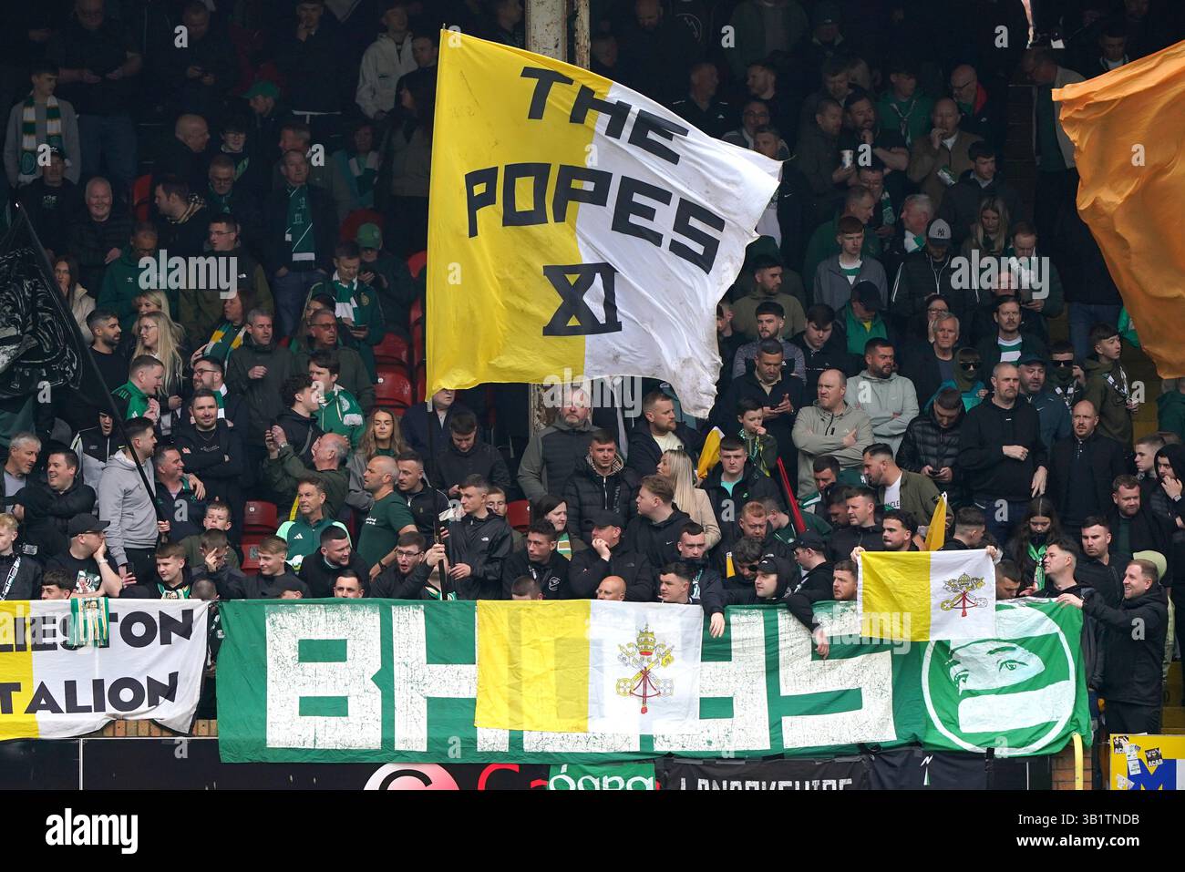 Celtic fans in the stands hold up tributes to the late Pope Francis ...