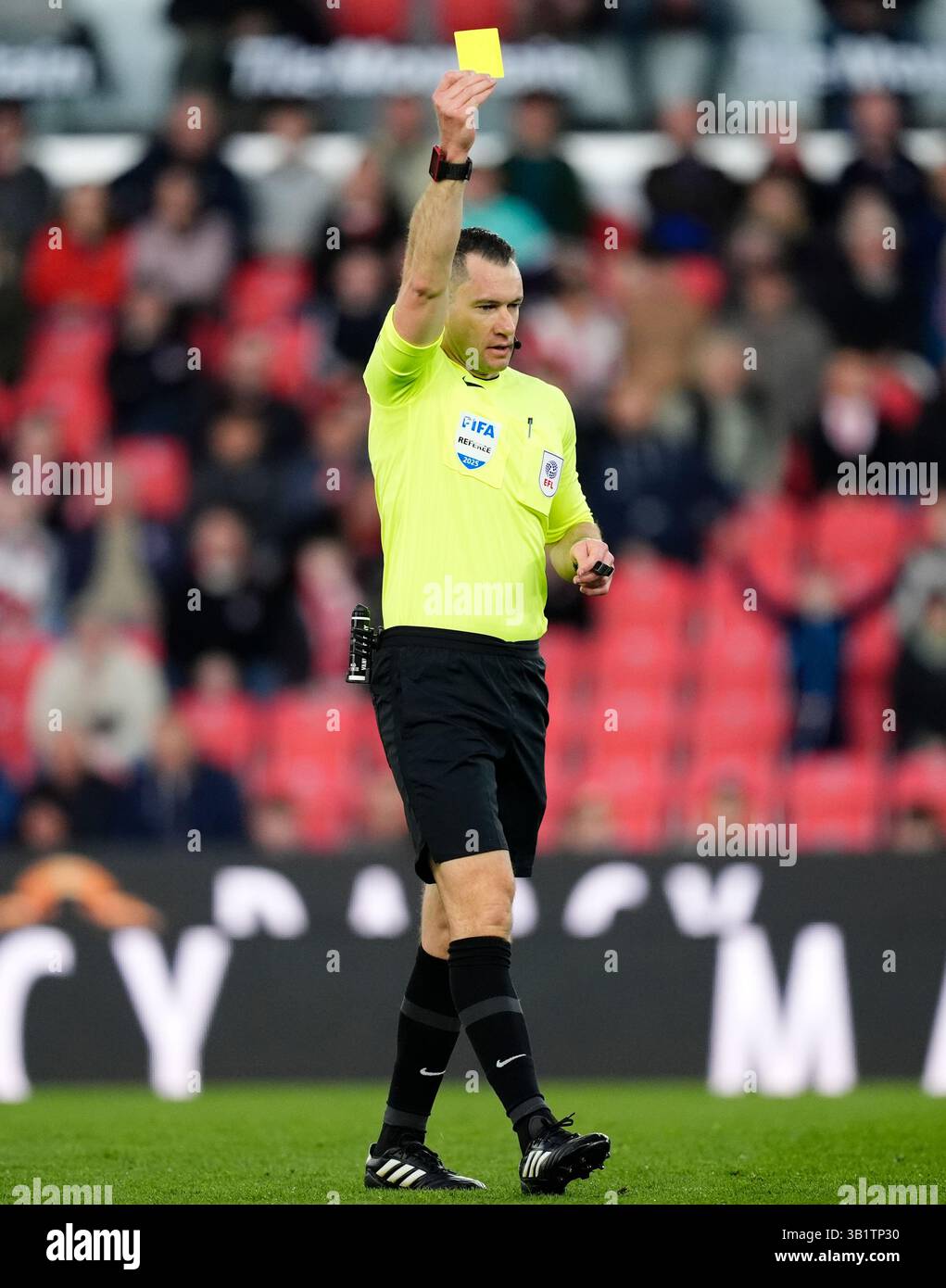Referee Jarred Gillett shows a yellow card during the Sky Bet ...