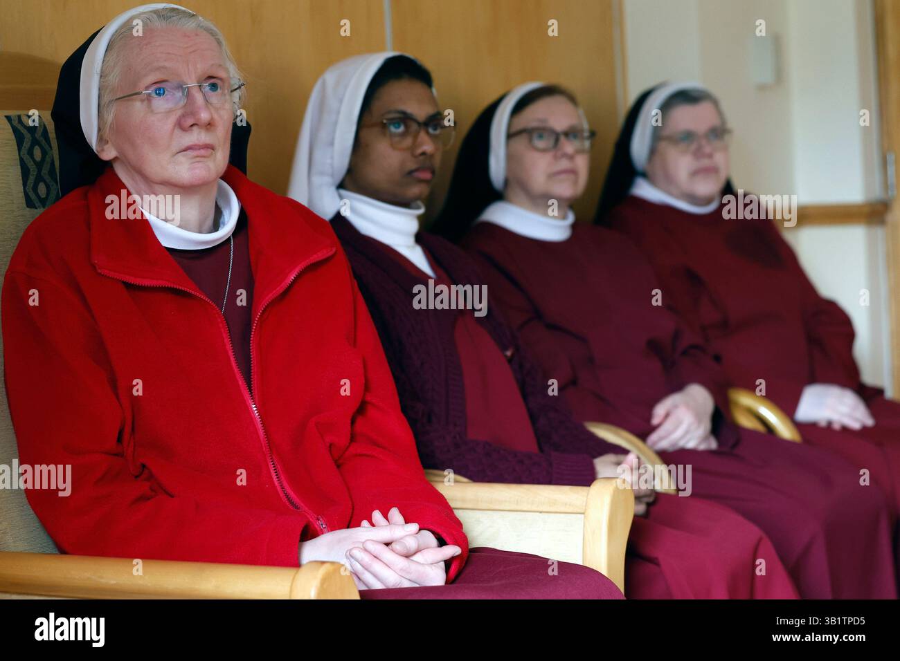 Sisters of the Redemptoristine Nuns, known as the Red Nuns, watch the ...
