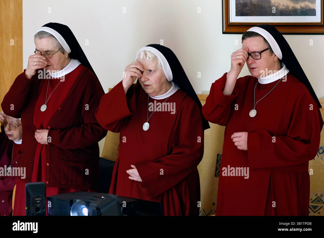 Sisters of the Redemptoristine Nuns, known as the Red Nuns, watch the ...