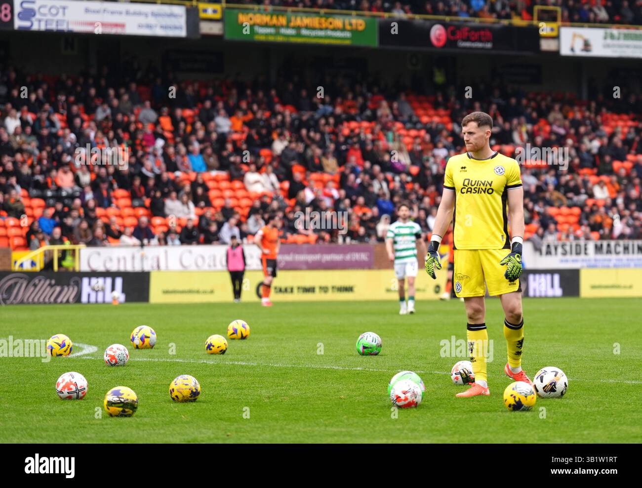 Dundee United goalkeeper Jack Walton removes balls that were thrown on ...