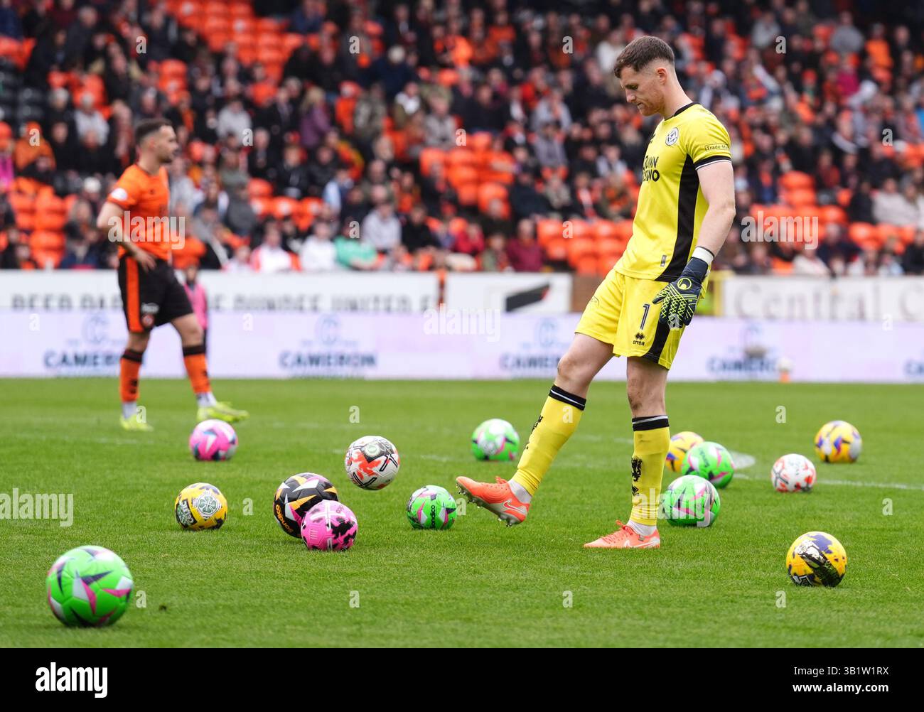 Dundee United goalkeeper Jack Walton removes balls that were thrown on ...