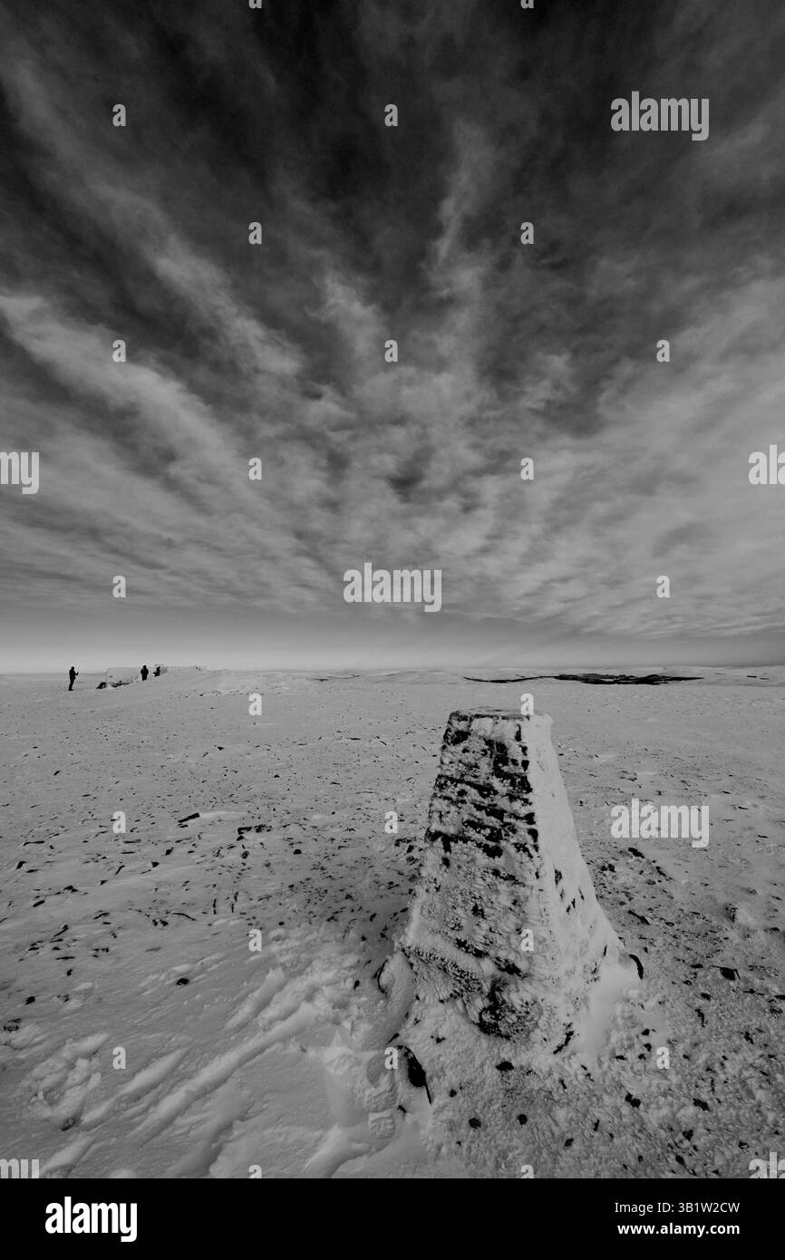 Winter snowy view of the OS Trig Point on the summit of Ingleborough ...