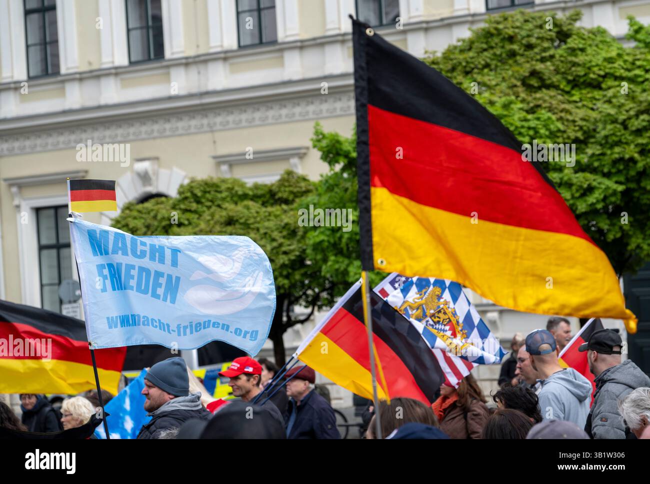 Munich, Germany. 26th Apr, 2025. People with German and peace flags ...