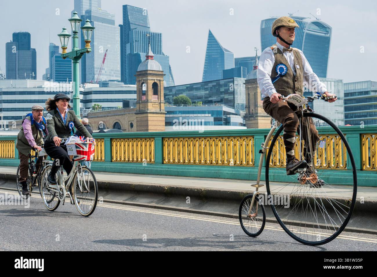 London, UK. 26th Apr, 2025. Crossing southwark bridge with the city of ...