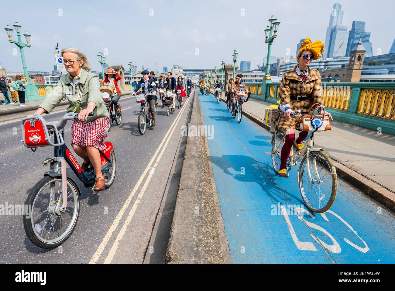 London, UK. 26th Apr, 2025. Crossing southwark bridge with the city of ...