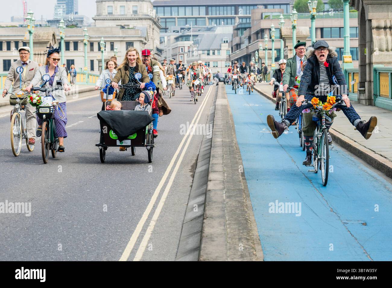 London, UK. 26th Apr, 2025. Crossing southwark bridge with the city of ...