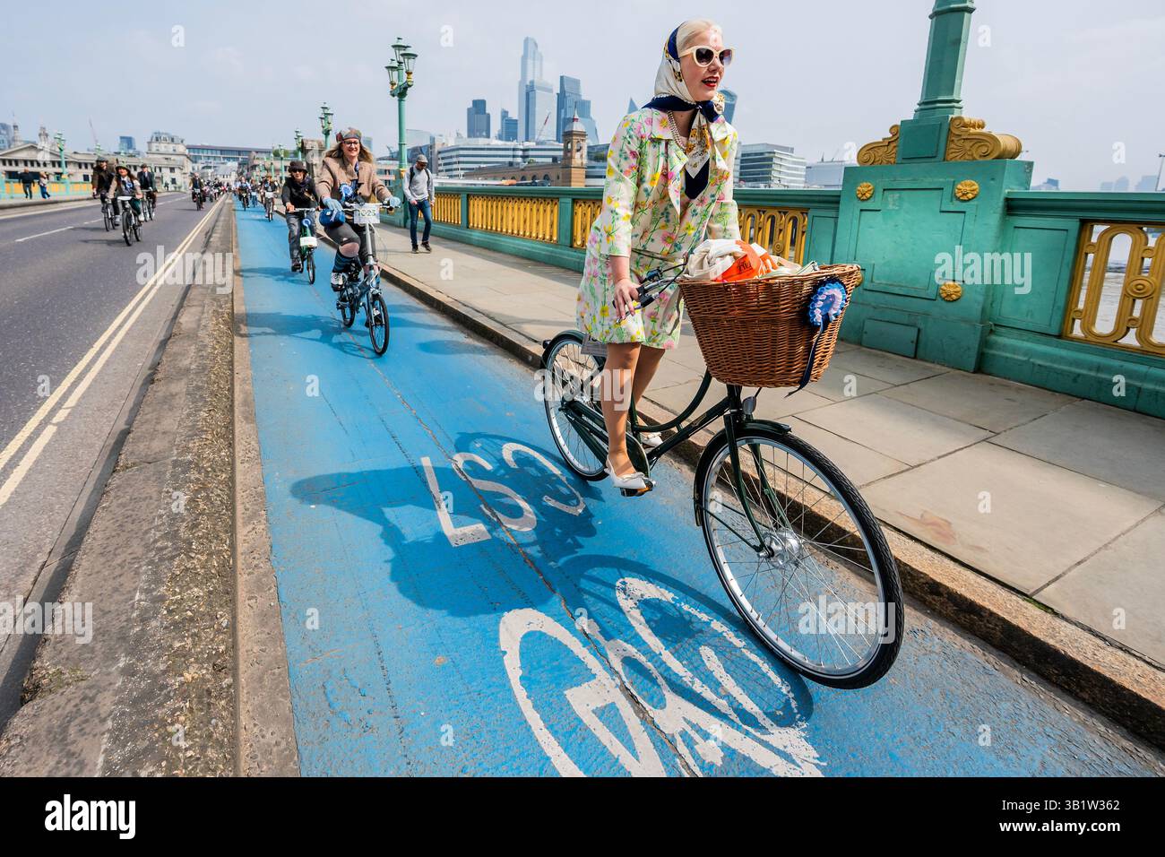 London, UK. 26th Apr, 2025. Crossing southwark bridge with the city of ...