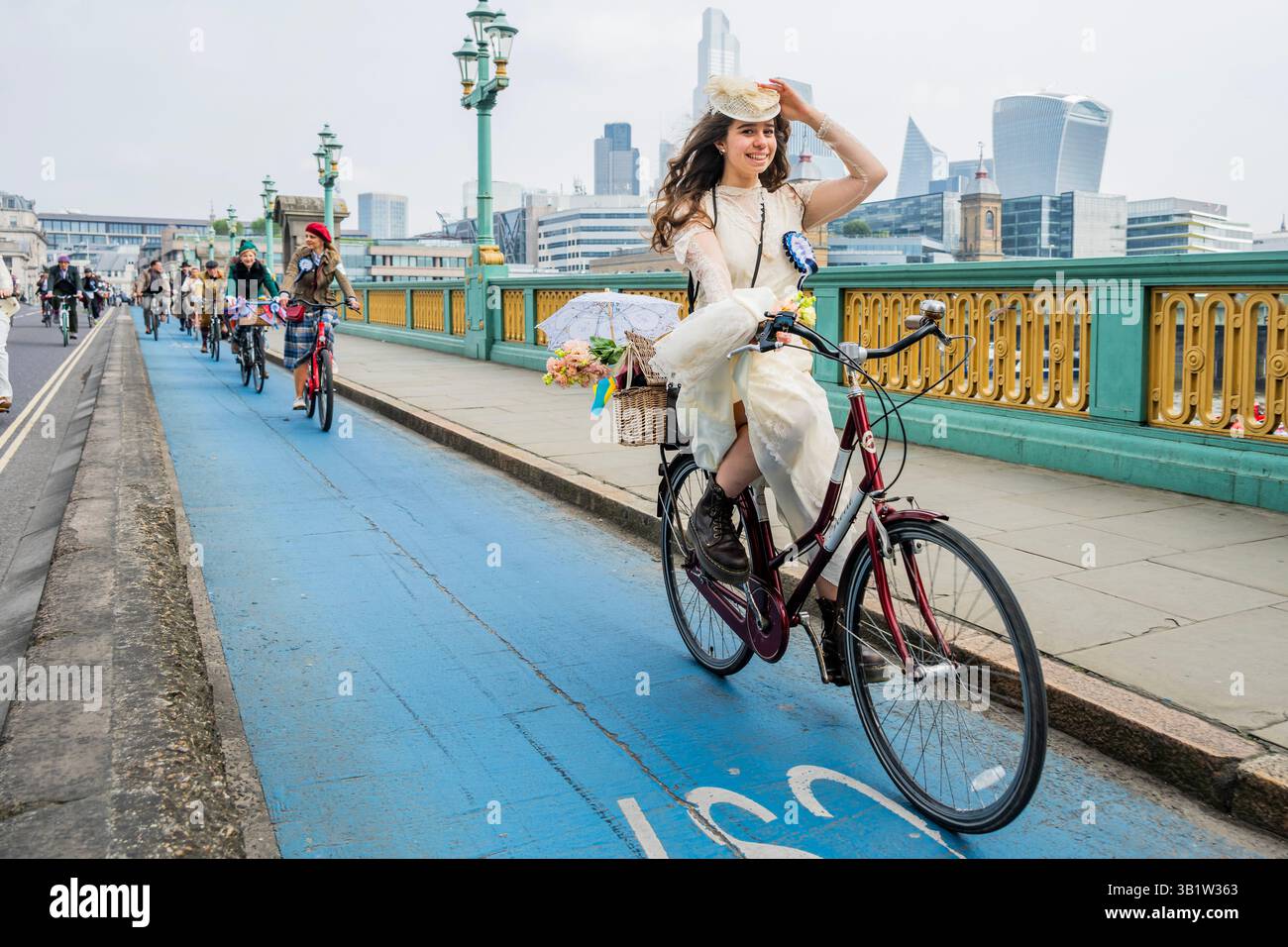 London, UK. 26th Apr, 2025. Crossing southwark bridge with the city of ...