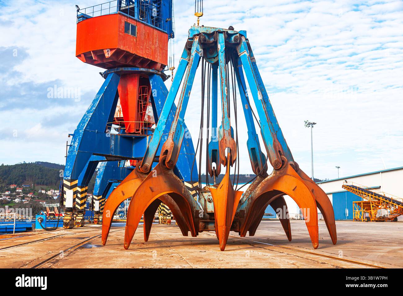 Harbor cranes and a standing grab bucket on the territory of the ...
