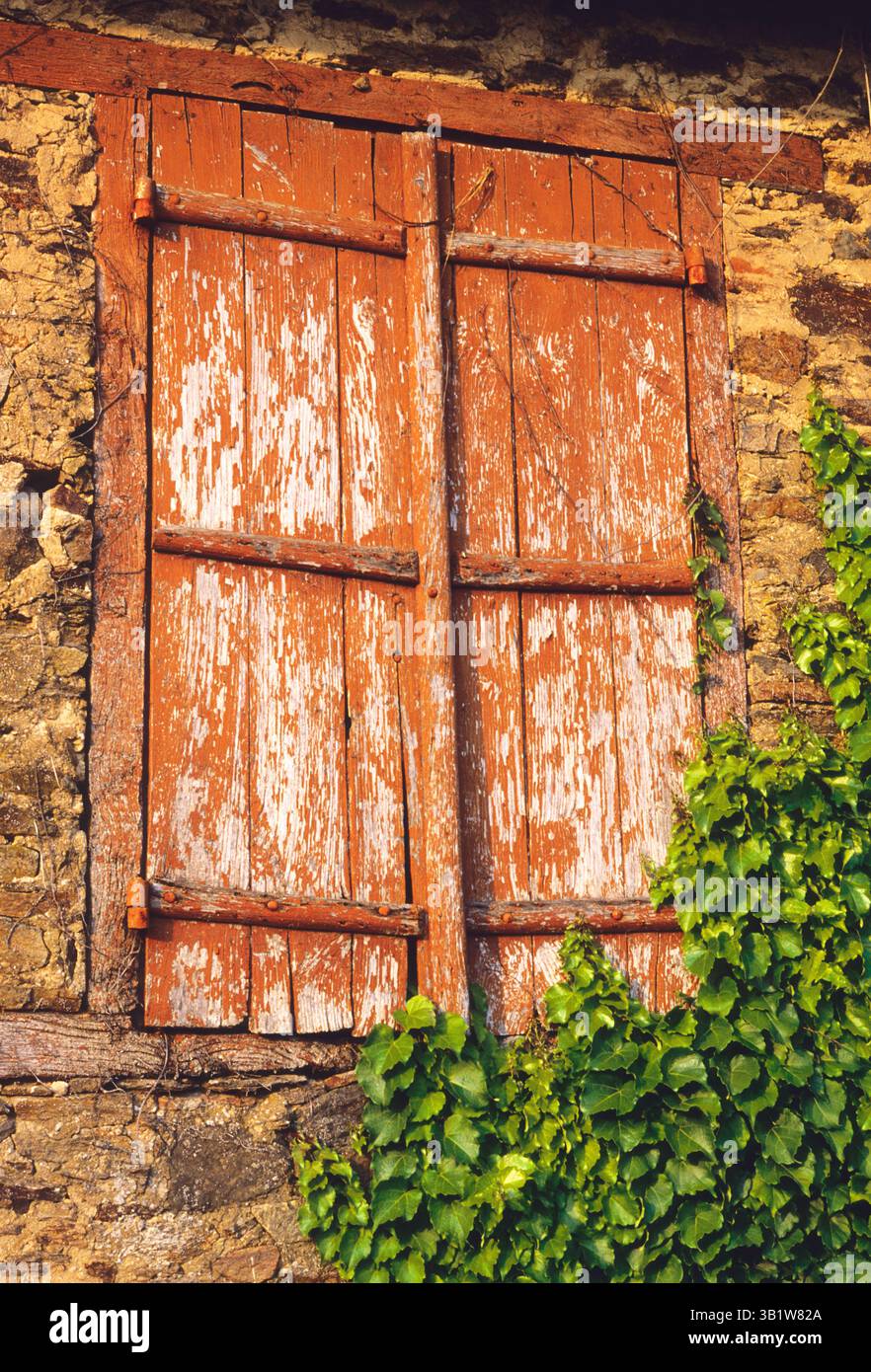 France Closed shuttered window of old farmhouse. Rustic old stone ...