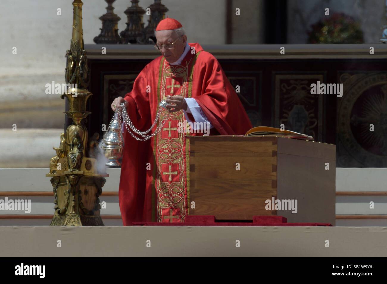 Cardinal Giovanni Battista Re blesses the coffin during the funeral of ...