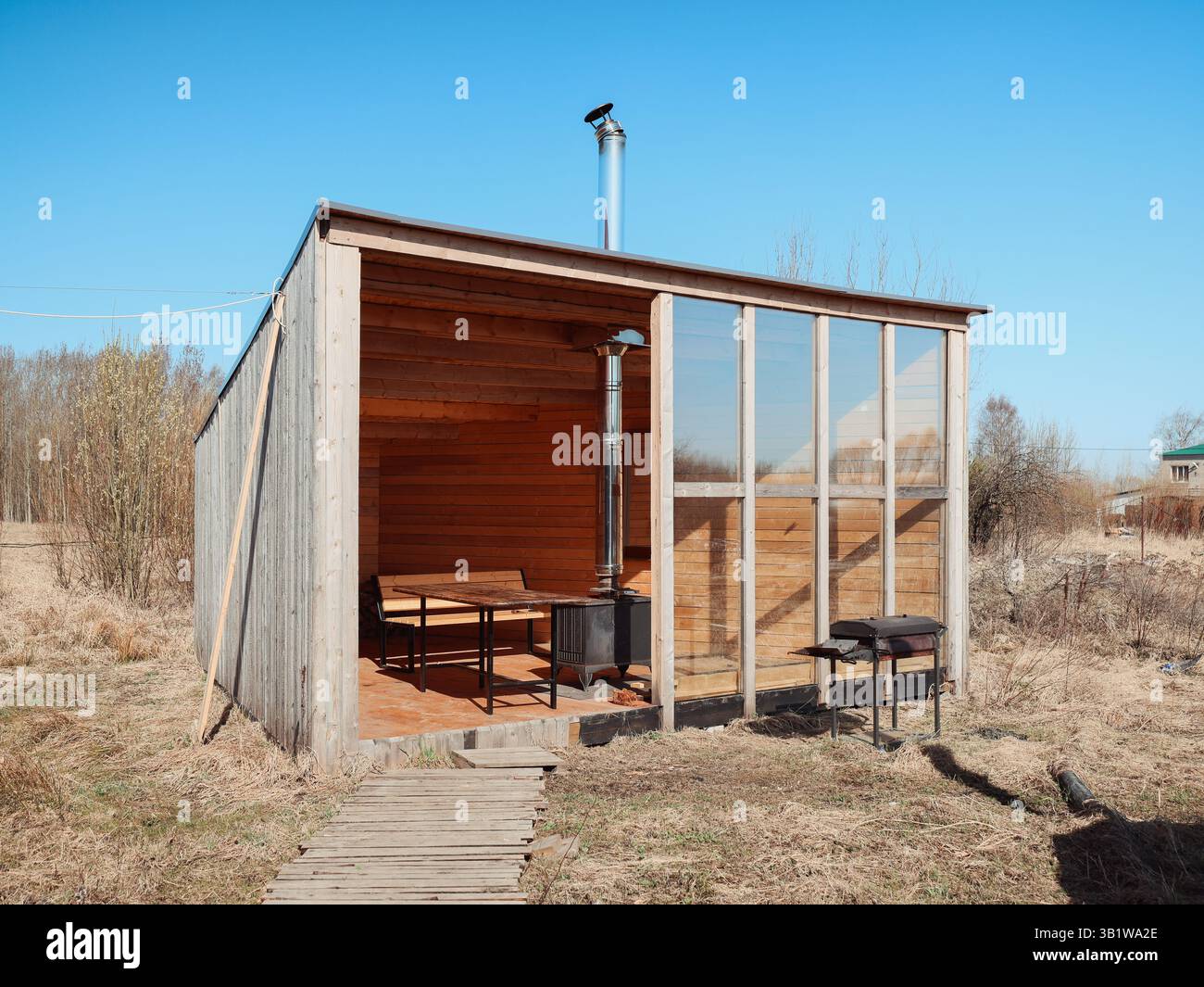 A Modern Wooden Cabin Featuring Expansive Glass Walls Nestled in a ...