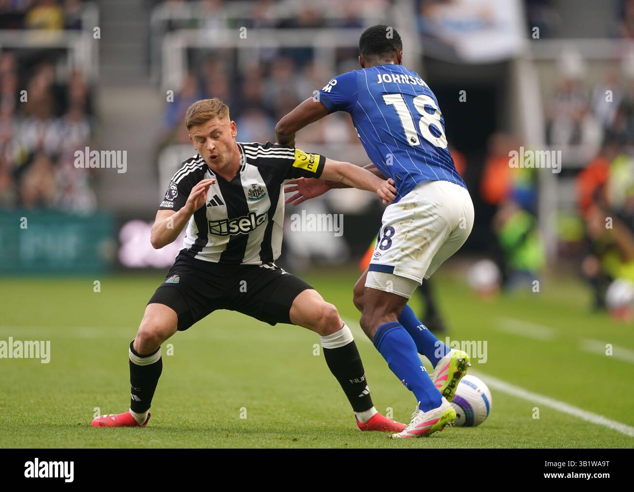 Newcastle United's Harvey Barnes (left) and Ipswich Town's Ben Johnson ...