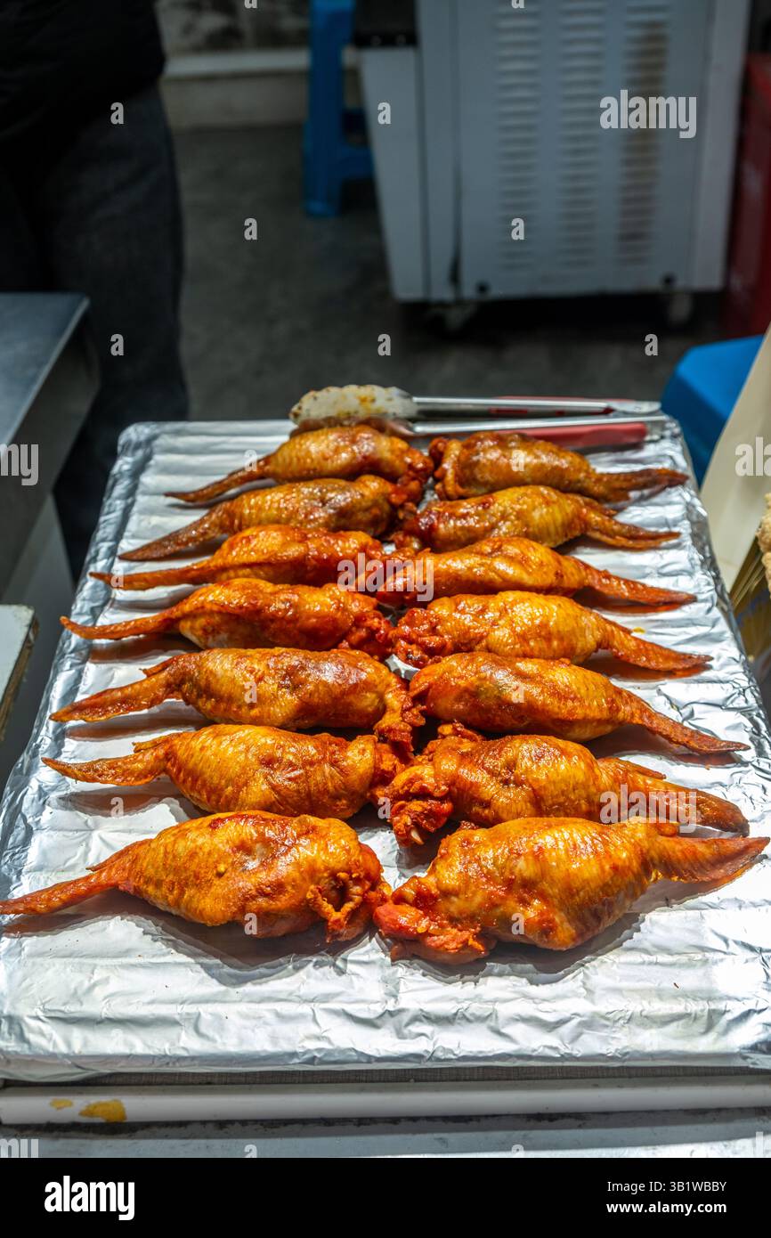 Chinese street food stall. Stuffed chicken wings on a display closeup ...