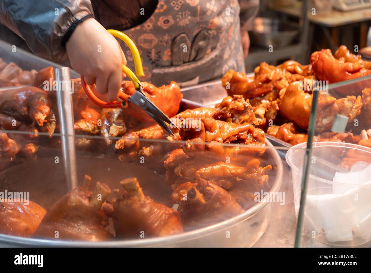 Pork trotters, pig feet at a street food stall, closeup view. Popular ...