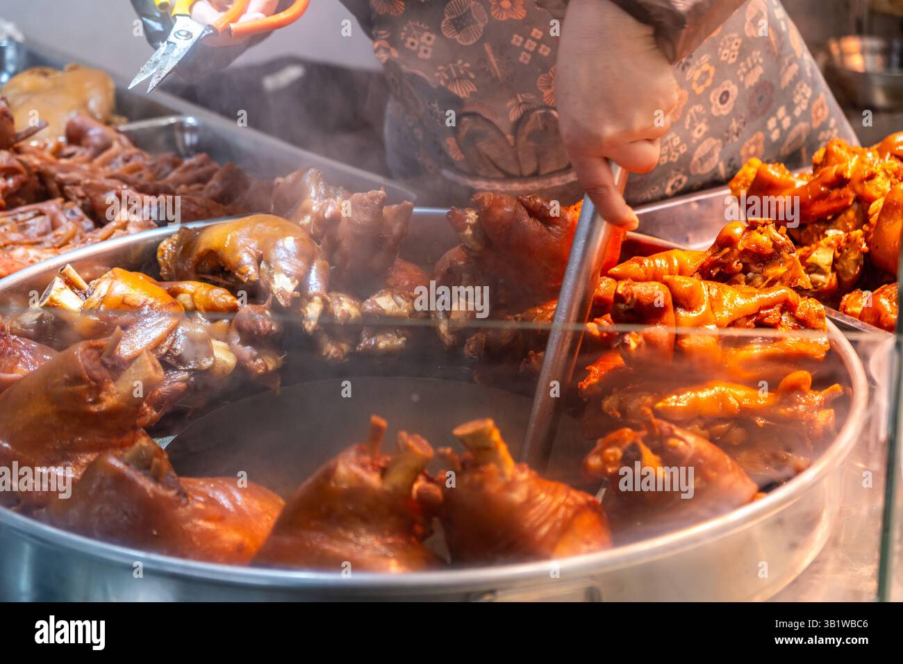 Pork trotters, pig feet at a street food stall, closeup view. Popular ...