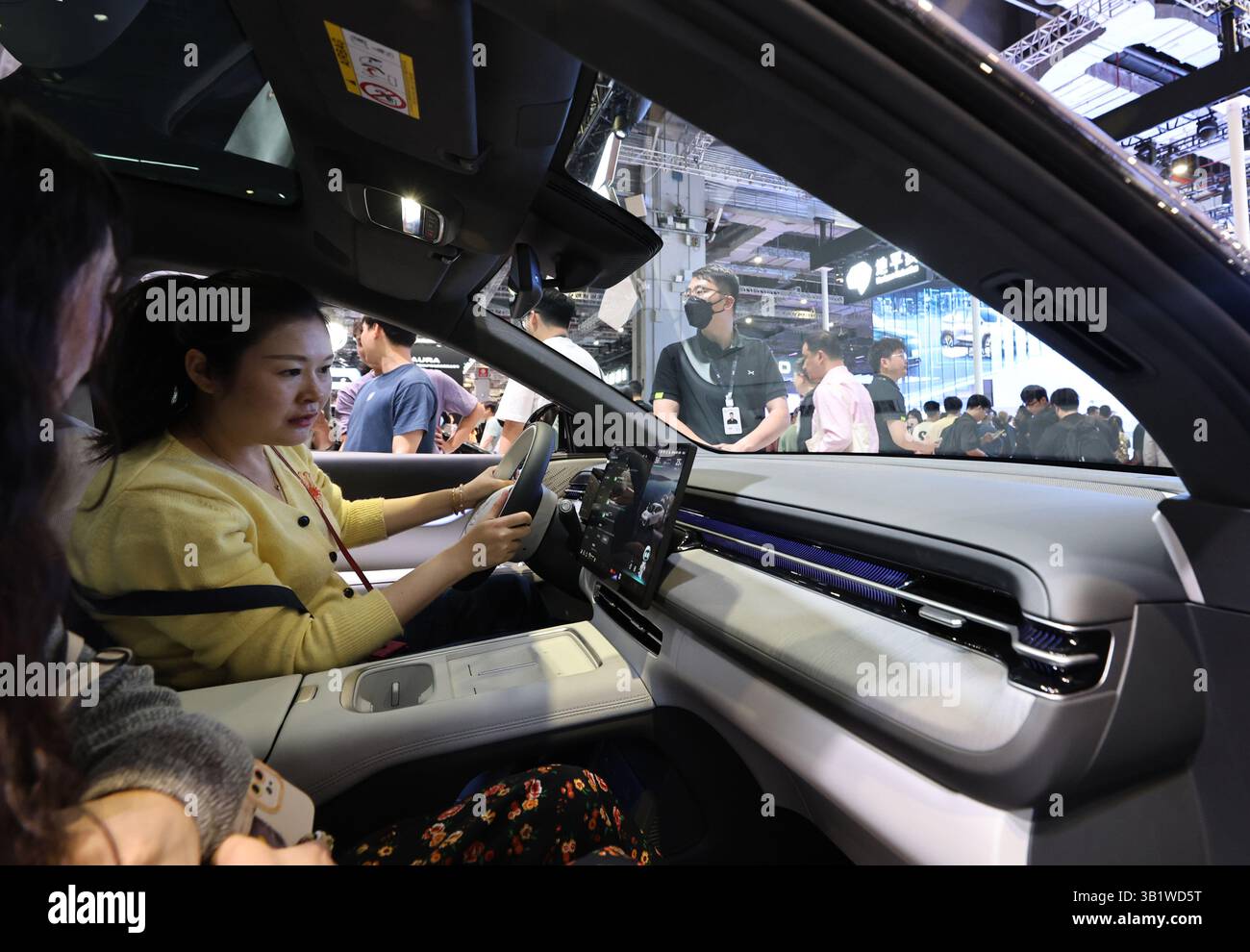 Shanghai. 26th Apr, 2025. Visitors sit in an Xpeng G6 on display at the ...