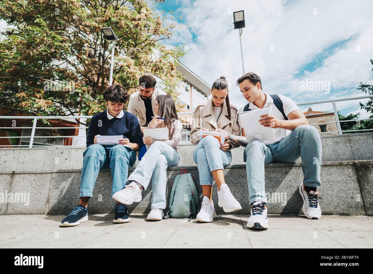 High school students studying outdoors with teacher guidance Stock ...