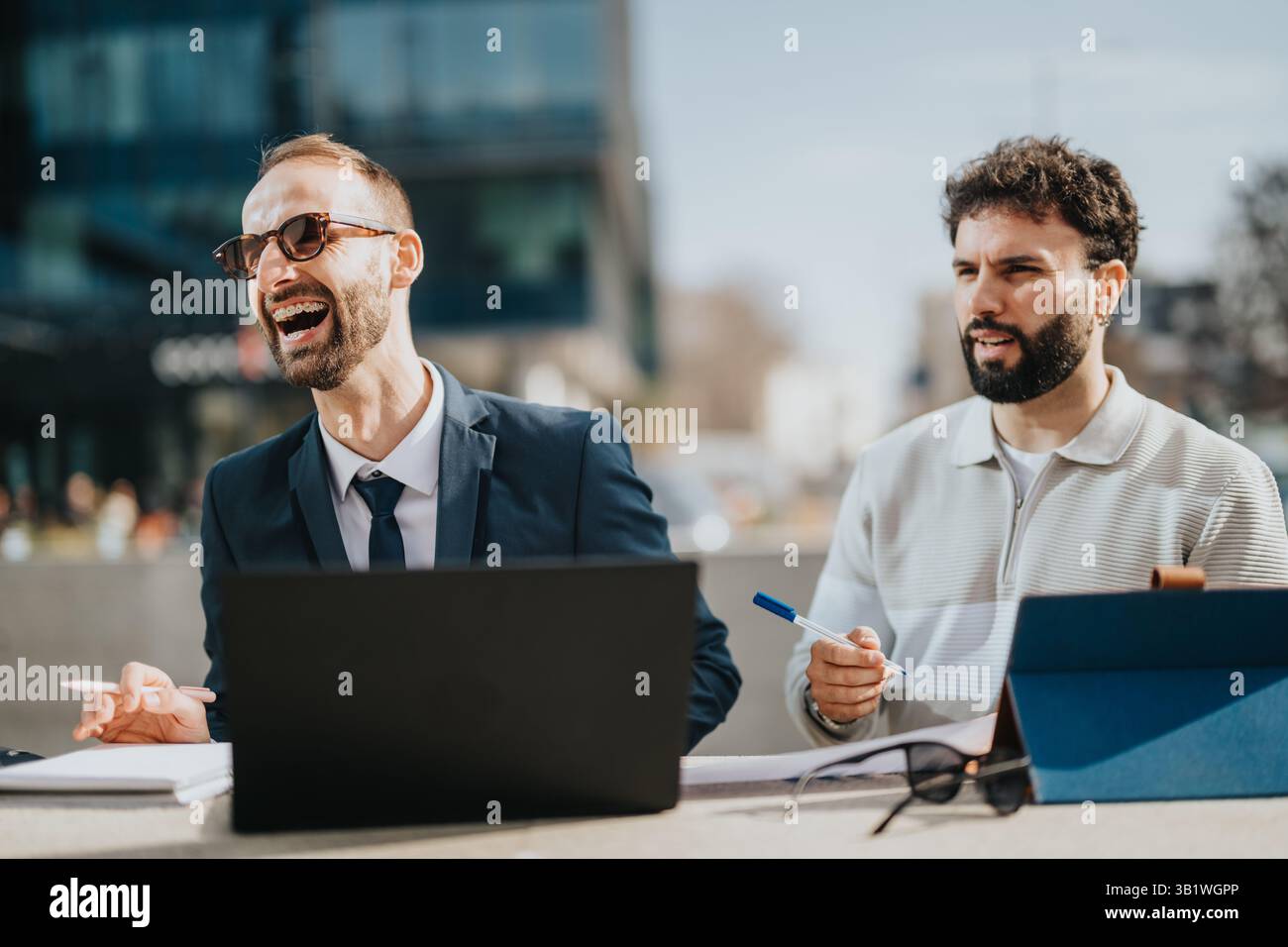 Two colleagues sharing a moment of happiness during an outdoor work ...