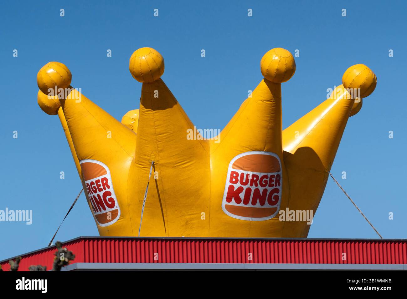 Hesse, Germany - April 26, 2025: A large, yellow inflatable crown with ...