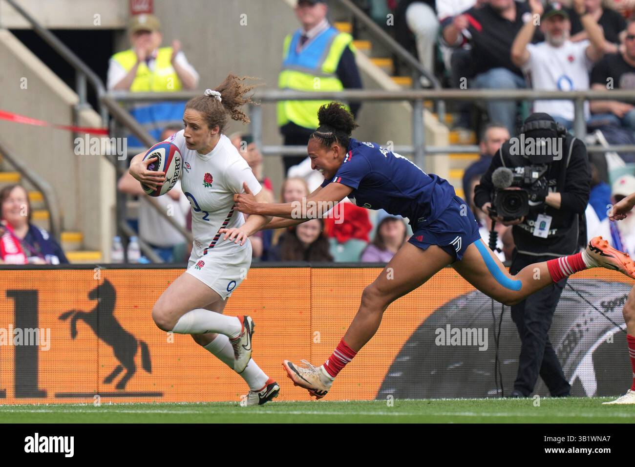 England's Abby Dow, left, on her way to score a try whilst Kelly Arby ...