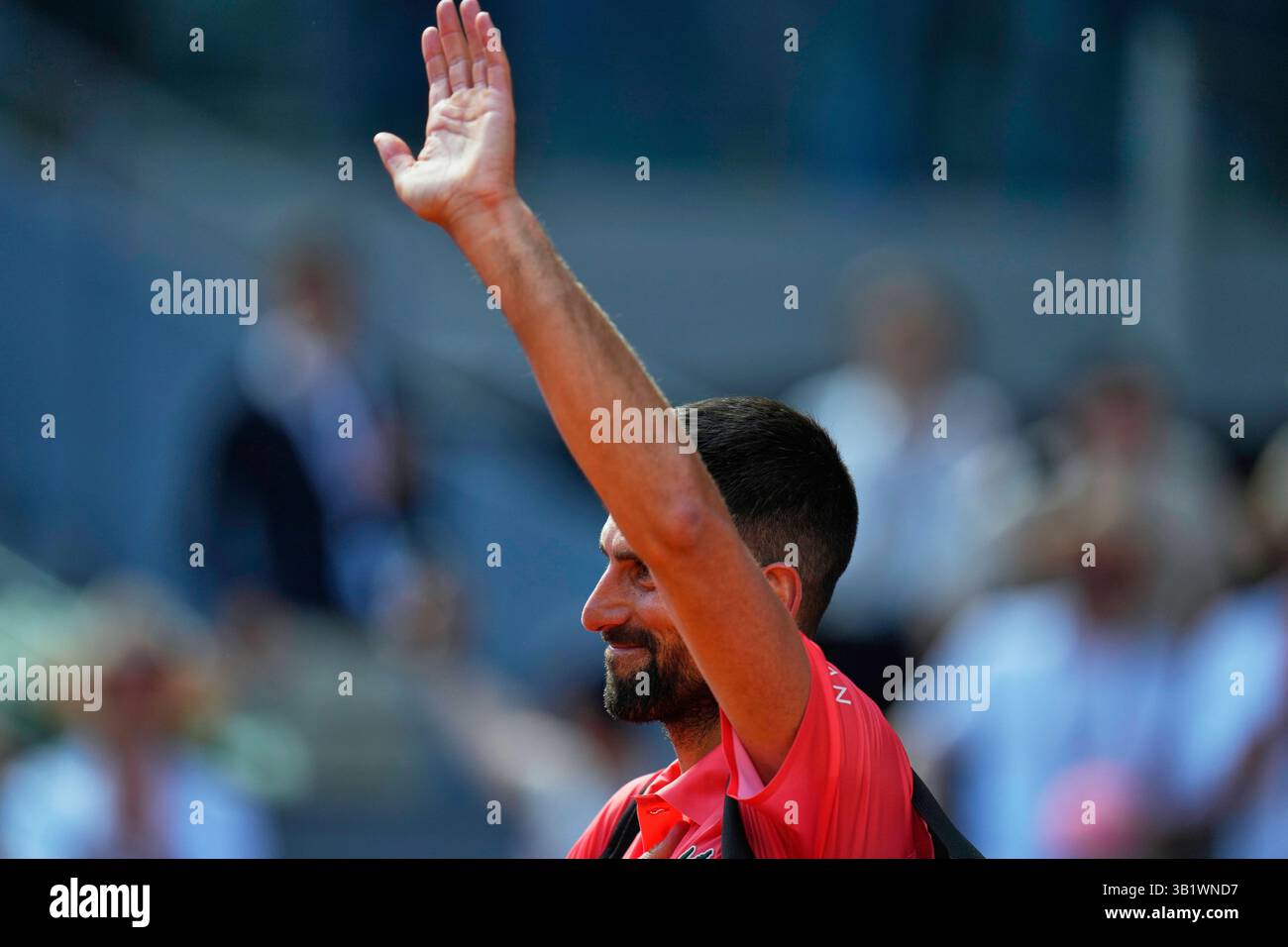 Novak Djokovic of Serbia waves to the crowd after losing against Matteo ...