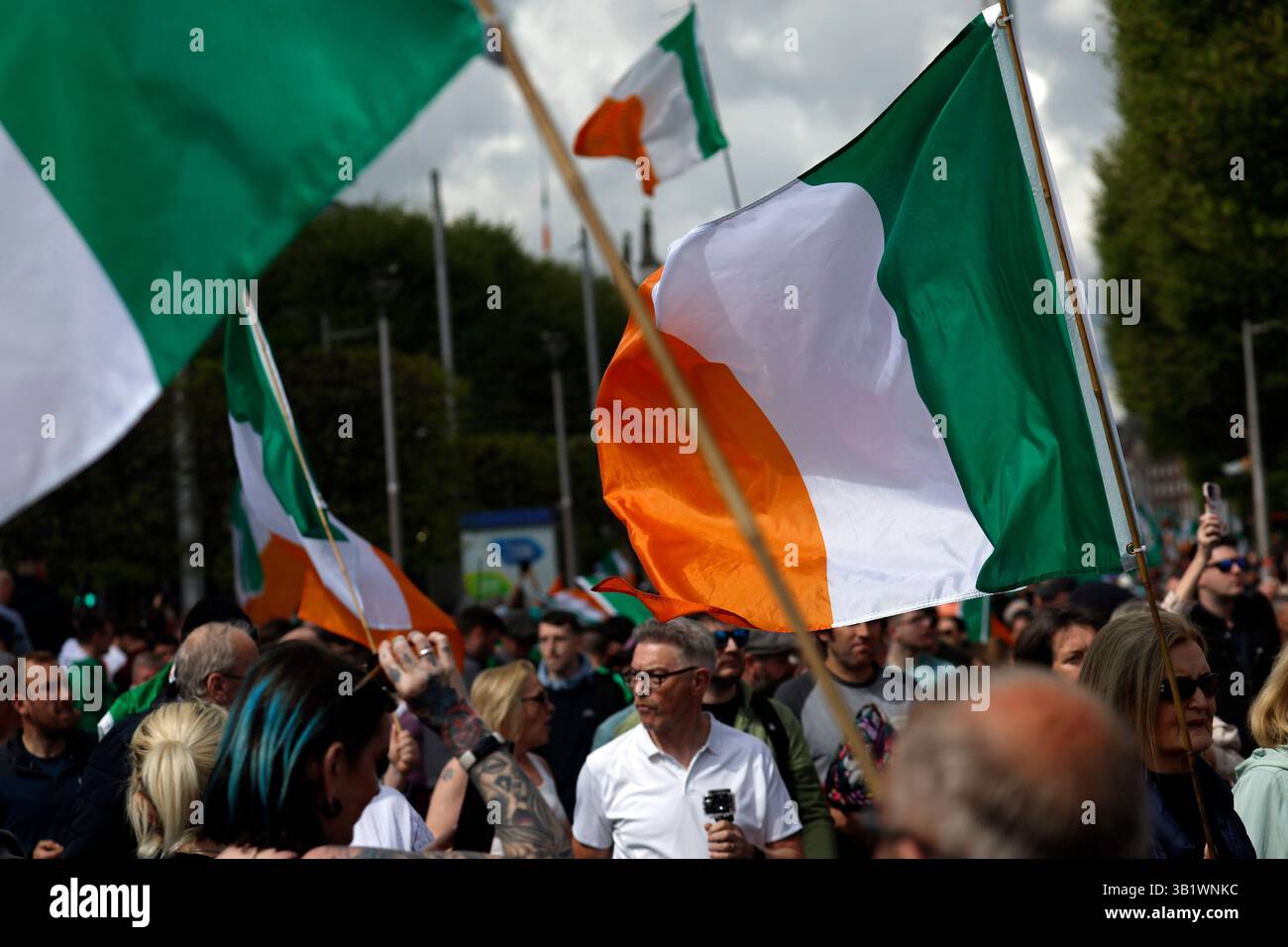 People take part in an anti-immigration protest in Dublin City centre ...