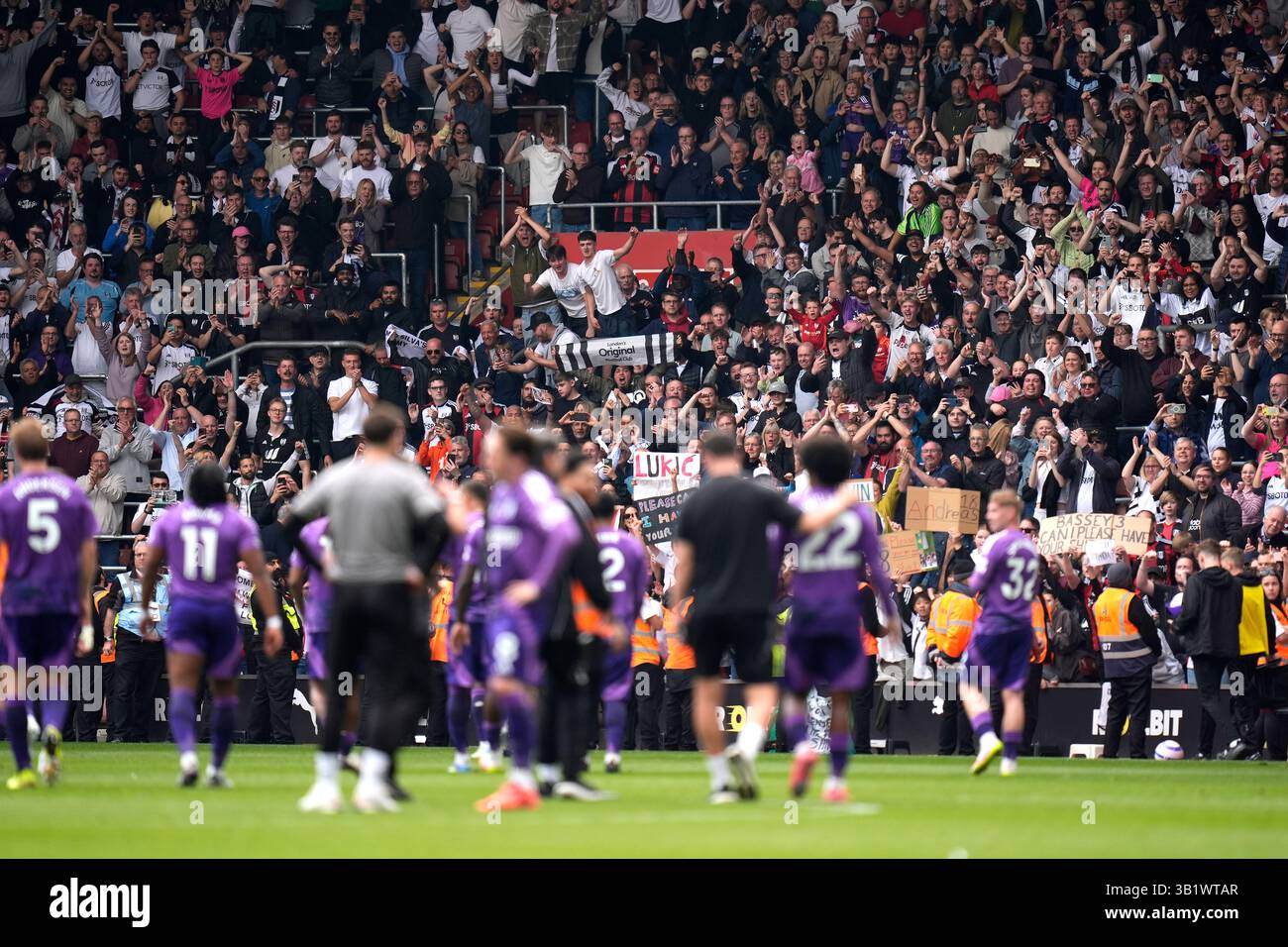 Fulham fans celebrate victory in the away stand following the Premier ...