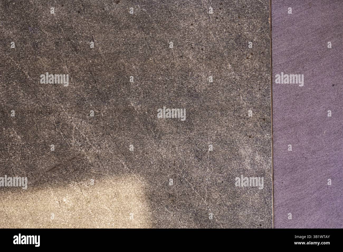 Rough-textured concrete and stone tiles with natural scratches and ...