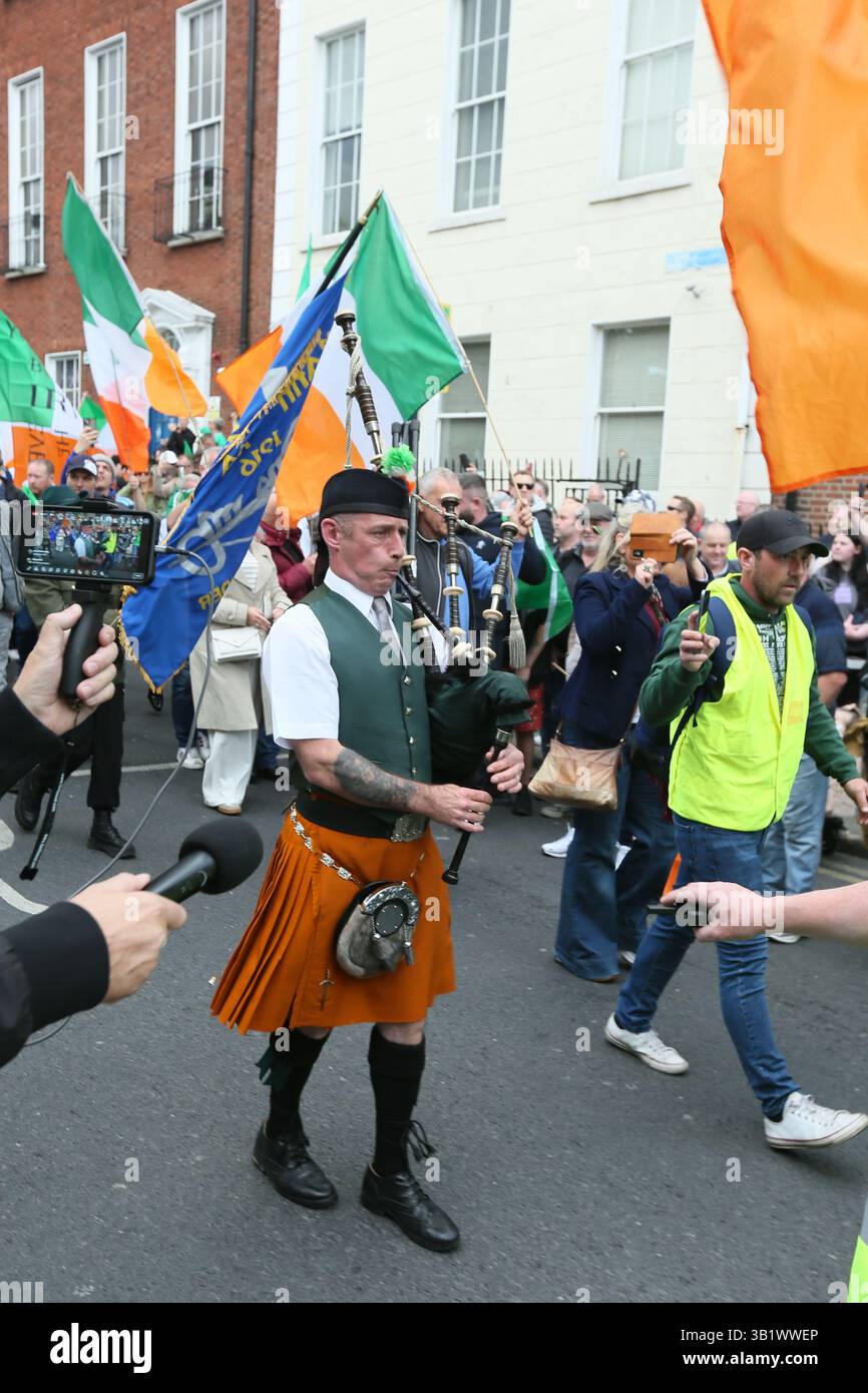 Dublin, Ireland - 26th April 2025 - A bagpiper leads the National ...