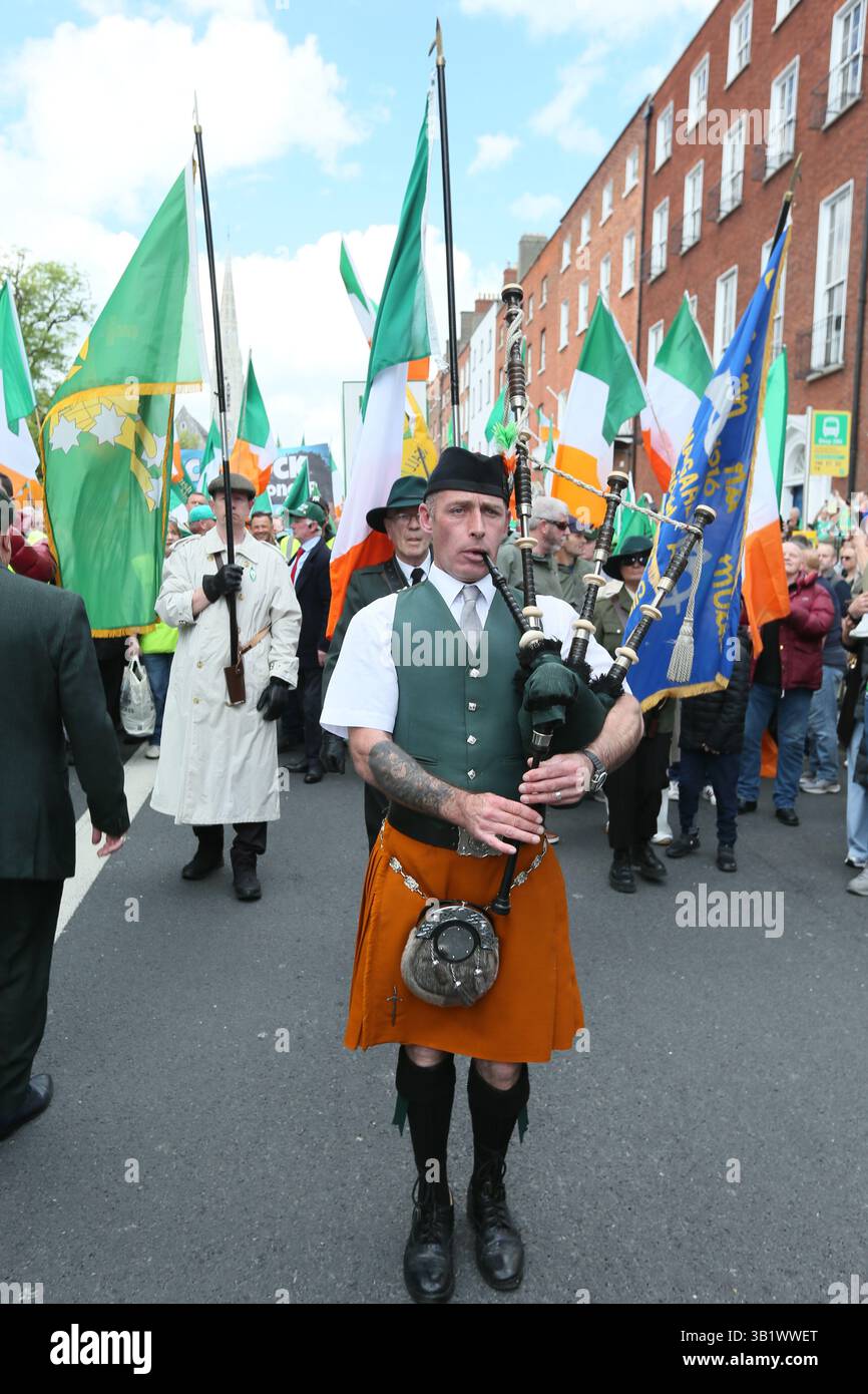 Dublin, Ireland - 26th April 2025 - A bagpiper leads the National ...