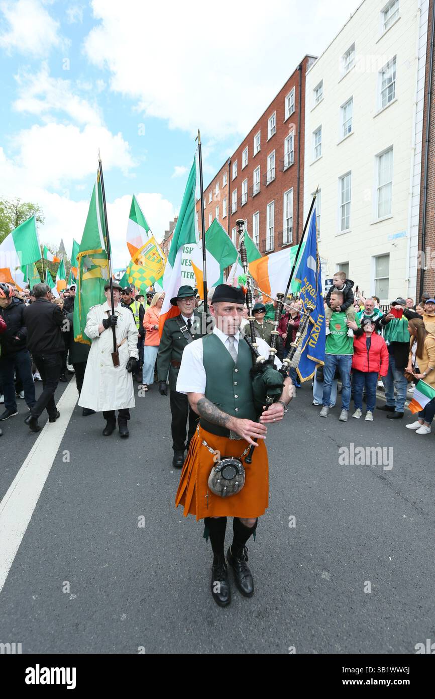Dublin, Ireland - 26th April 2025 - A bagpiper leads the National ...