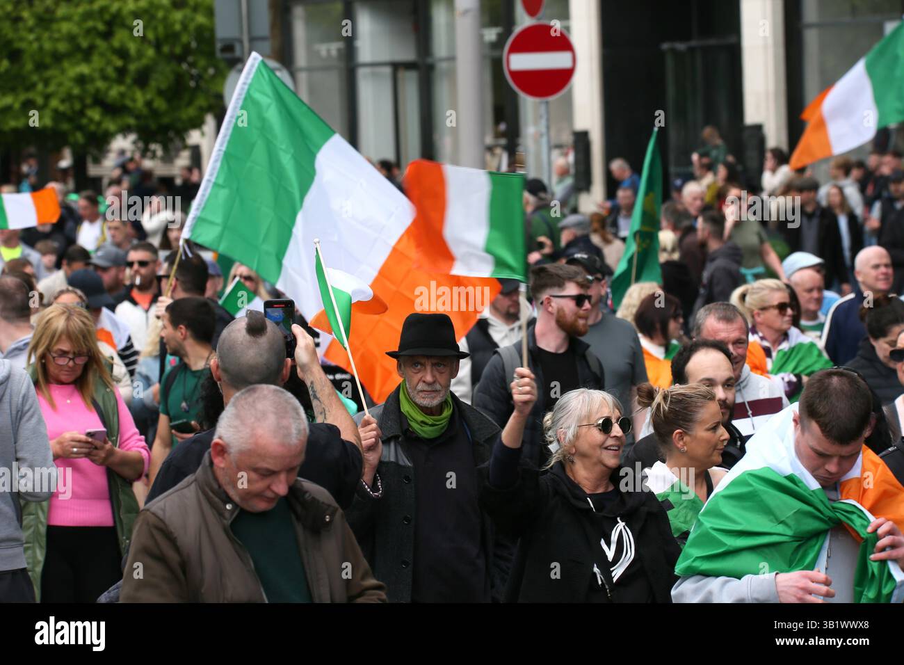 Dublin, Ireland - 26th April 2025 - Irish flags held up during the ...