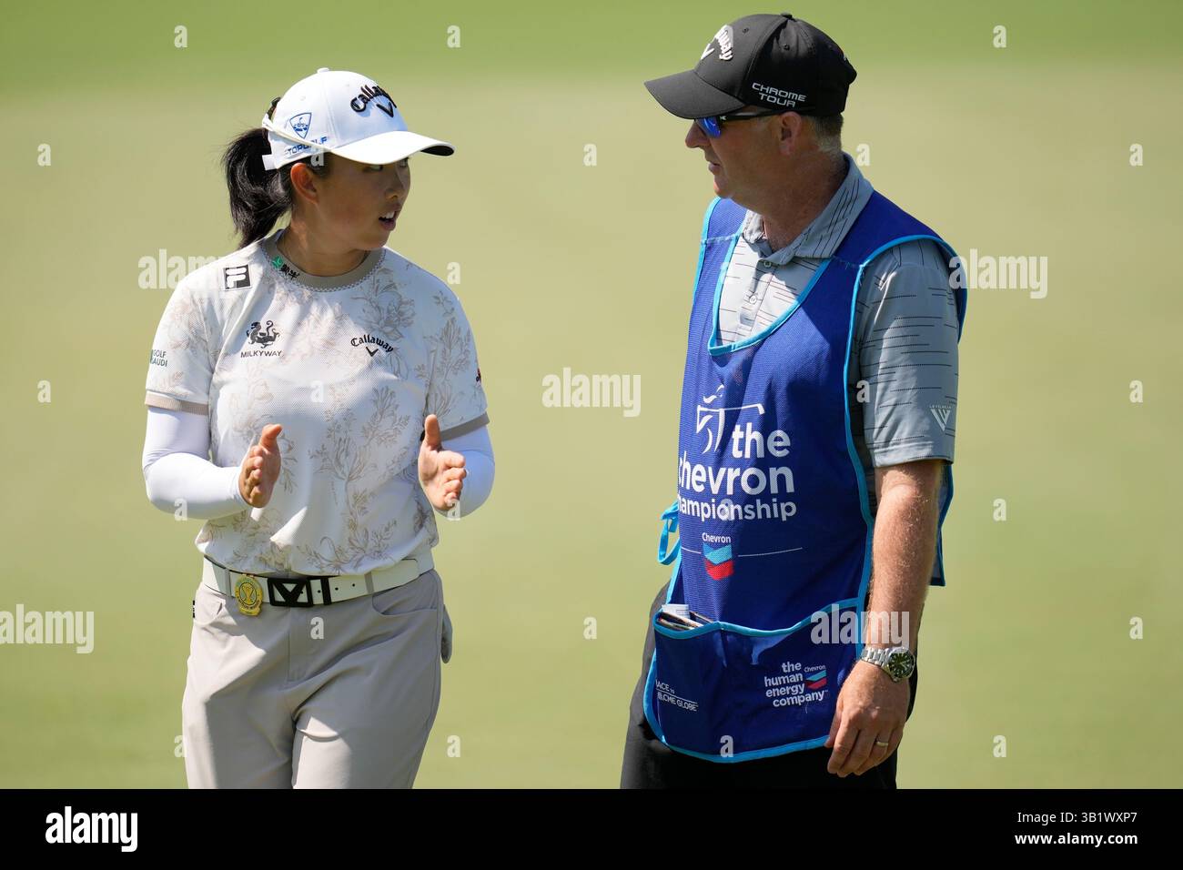 Ruoning Yin, of China, speaks to her caddie on the second green during ...