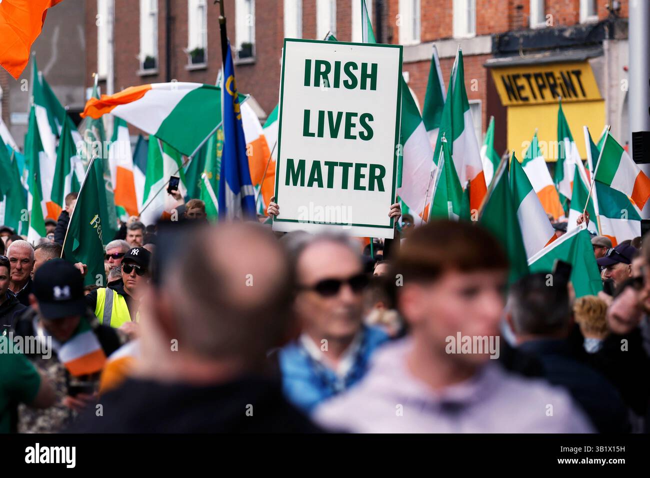 People take part in an anti-immigration protest in Dublin City centre ...