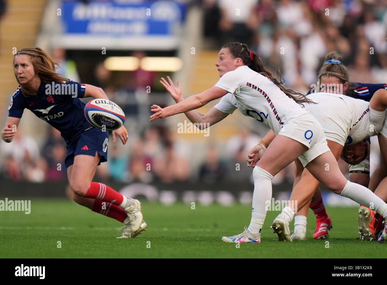 England's Lucy Packer, right, passes the ball as Pauline Bourdon Sansus ...