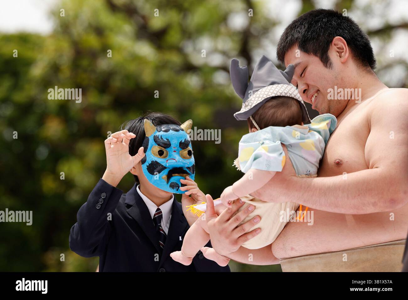 Tokyo, Japan. 26th Apr, 2025. A man wearing a devil mask makes a baby ...