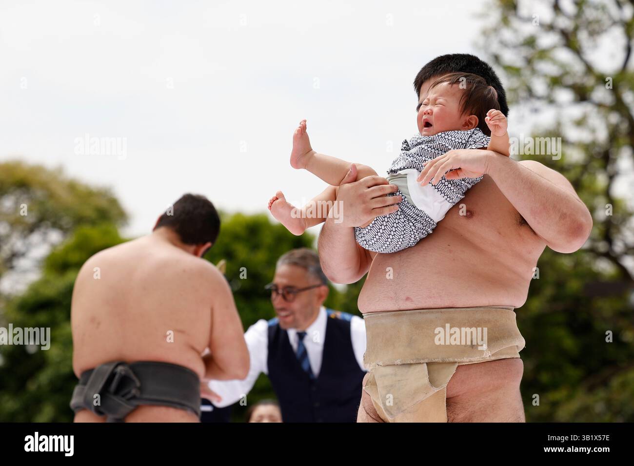 Tokyo, Japan. 26th Apr, 2025. A baby cries for good luck at the annual ...