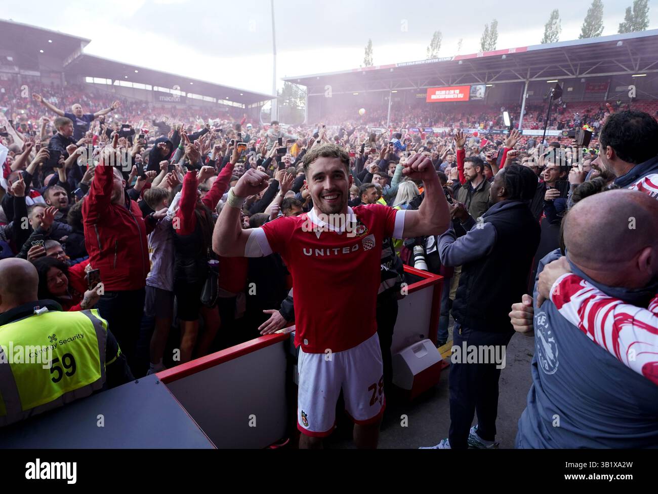 Wrexham's Sam Smith celebrates in front of the fans on the pitch after ...