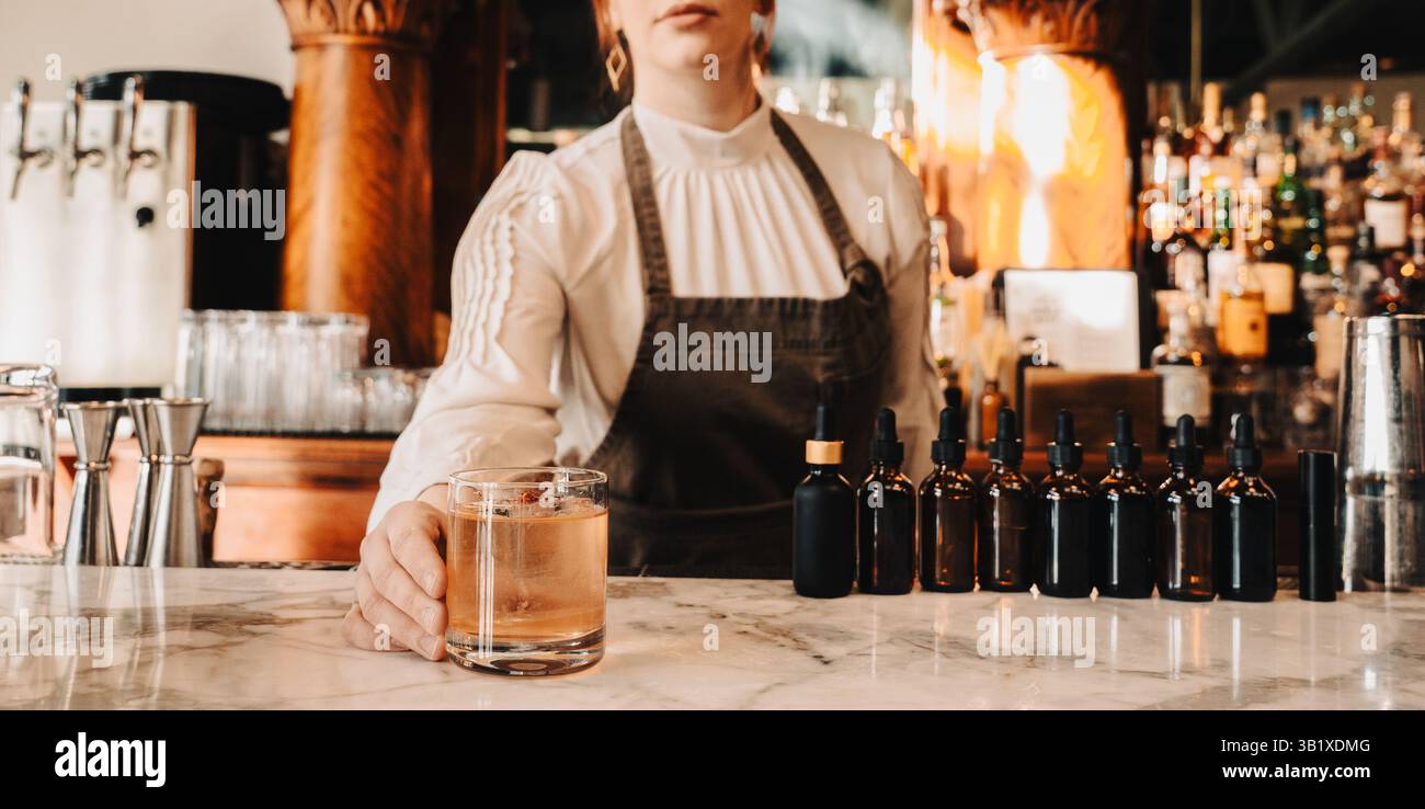 Bartender Serving Whiskey Cocktail on Marble Bar Stock Photo - Alamy