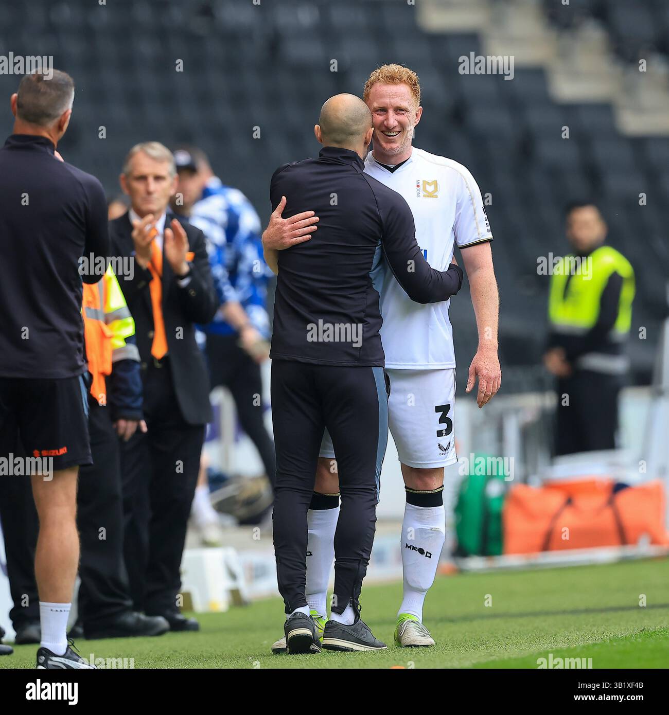Milton Keynes Dons Defender Dean Lewington (3) hugs Milton Keynes Dons ...