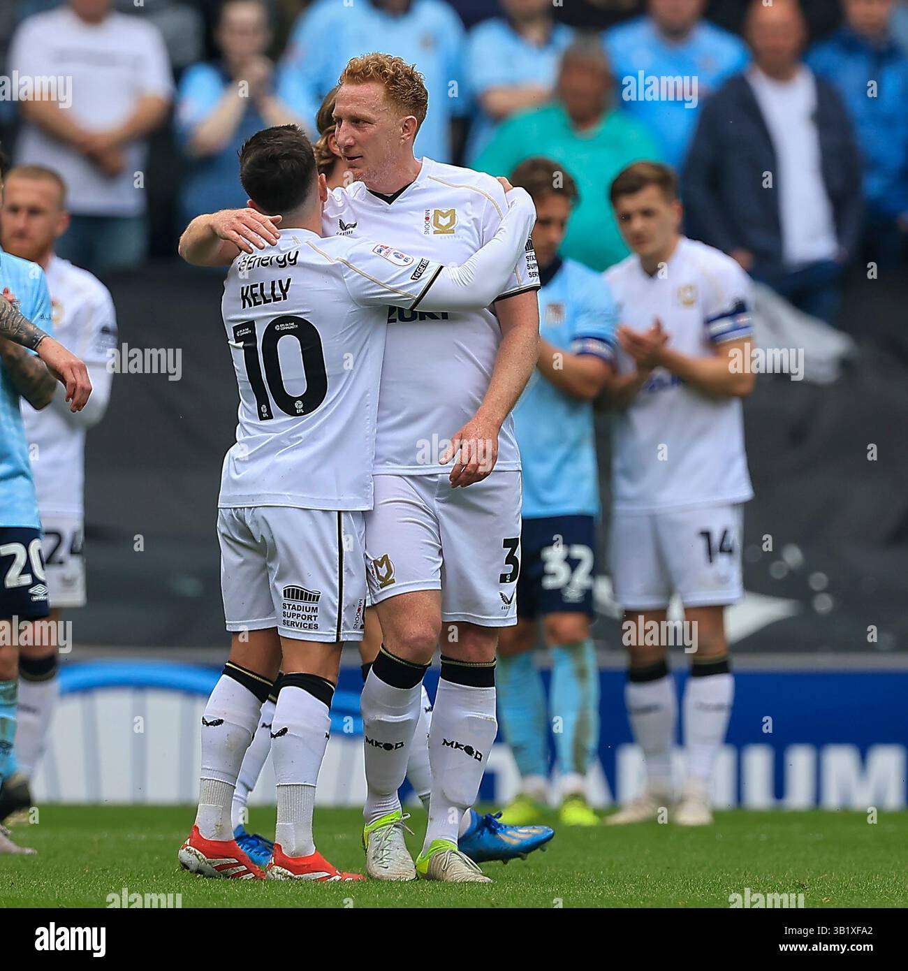 Milton Keynes Dons Midfielder Liam Kelly (10) hugs Milton Keynes Dons ...