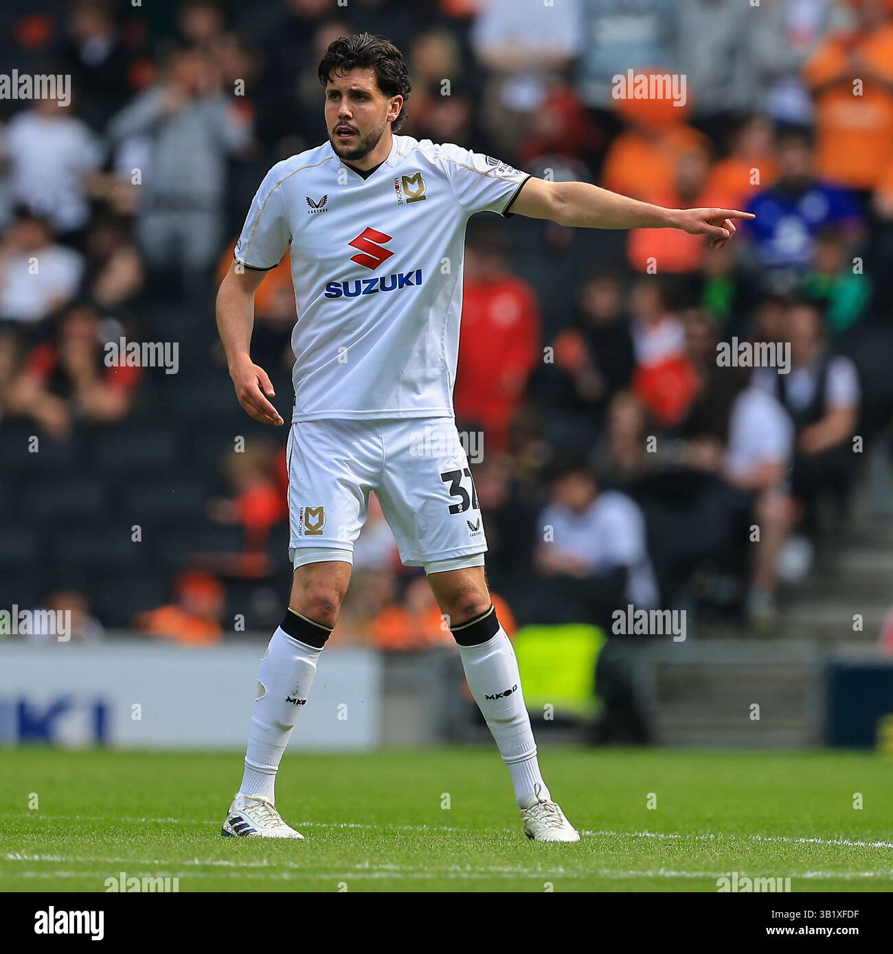 Milton Keynes Dons Defender Jack Sanders (32) Gestures to his teamates ...