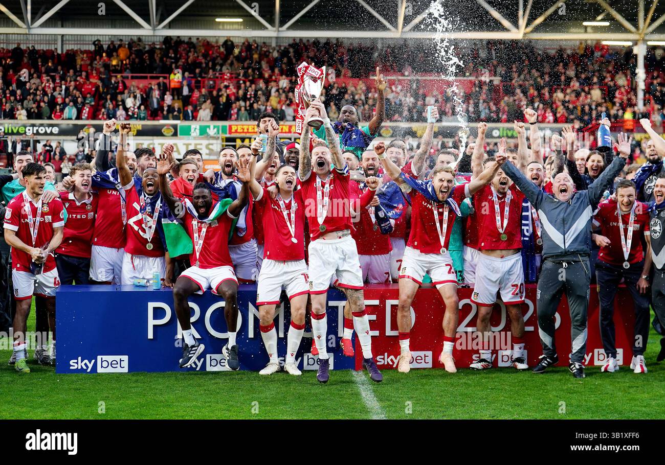 Wrexham's James McClean lifts the trophy after the Sky Bet League One ...