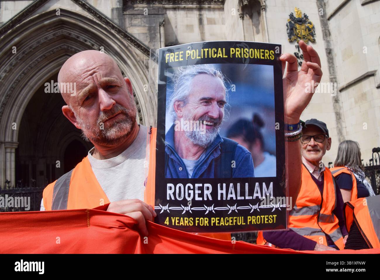 London, UK. 26th Apr, 2025. A Just Stop Oil activist stands outside the ...