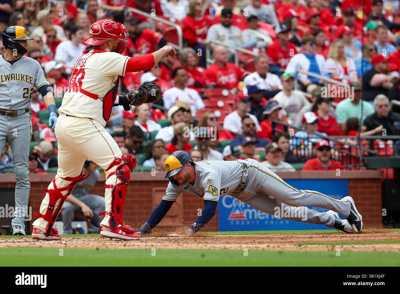 Milwaukee Brewers' Brice Turang, right, scores a run ahead of the throw ...