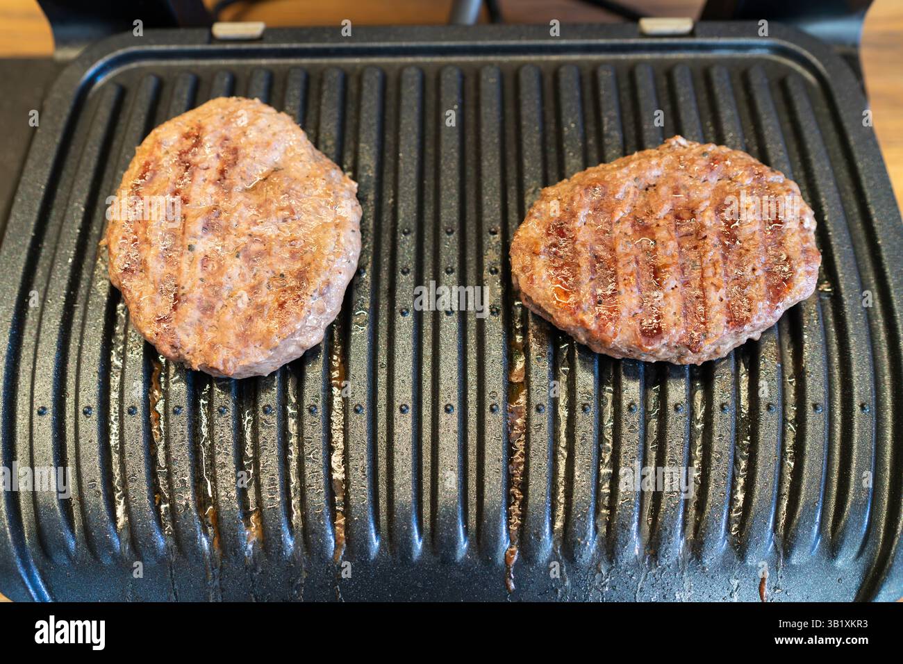Close-up of cooking juicy meat patties for homemade burgers on the ...