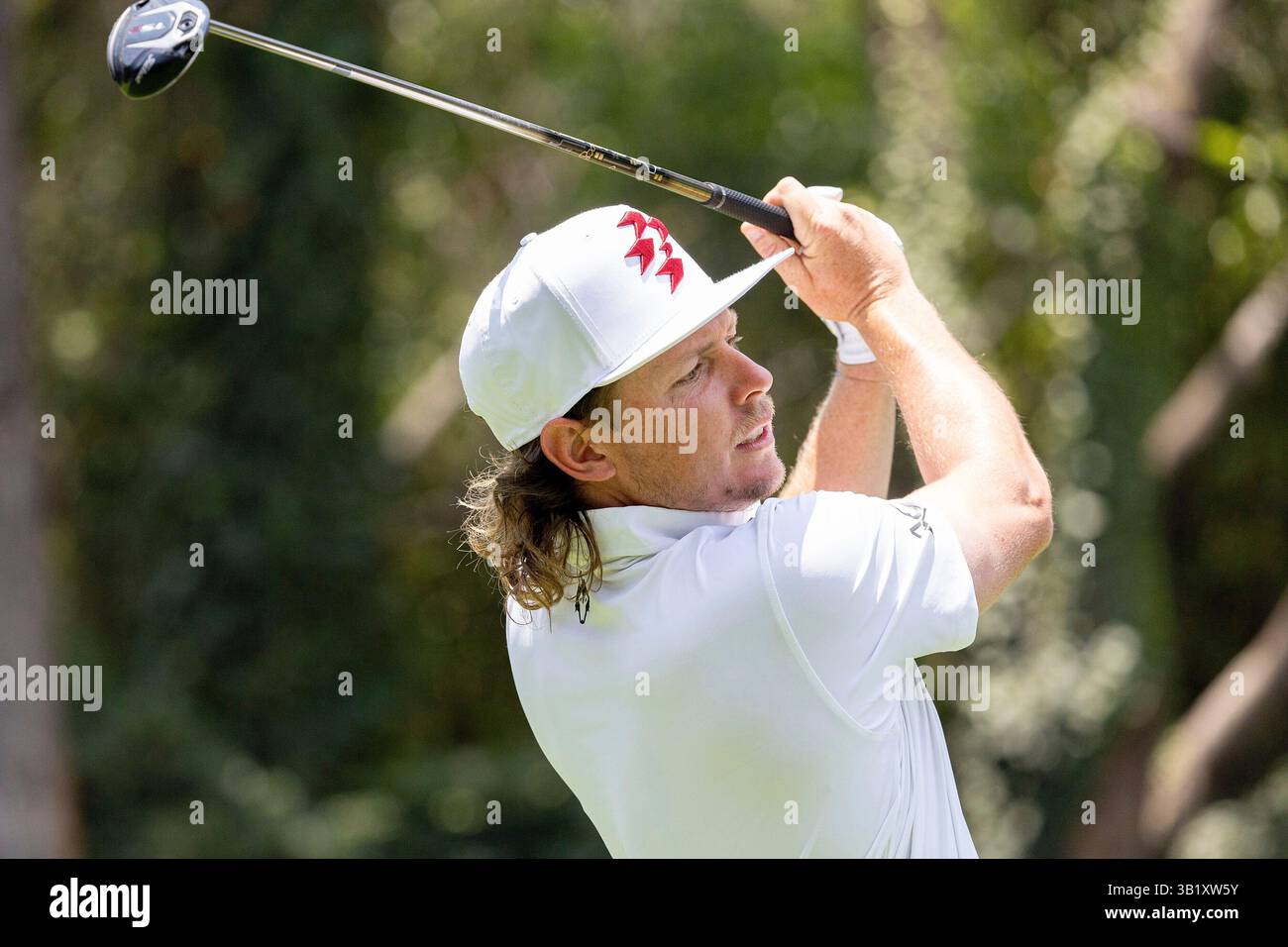 Captain Cameron Smith of Ripper GC hits his shot from the second tee ...